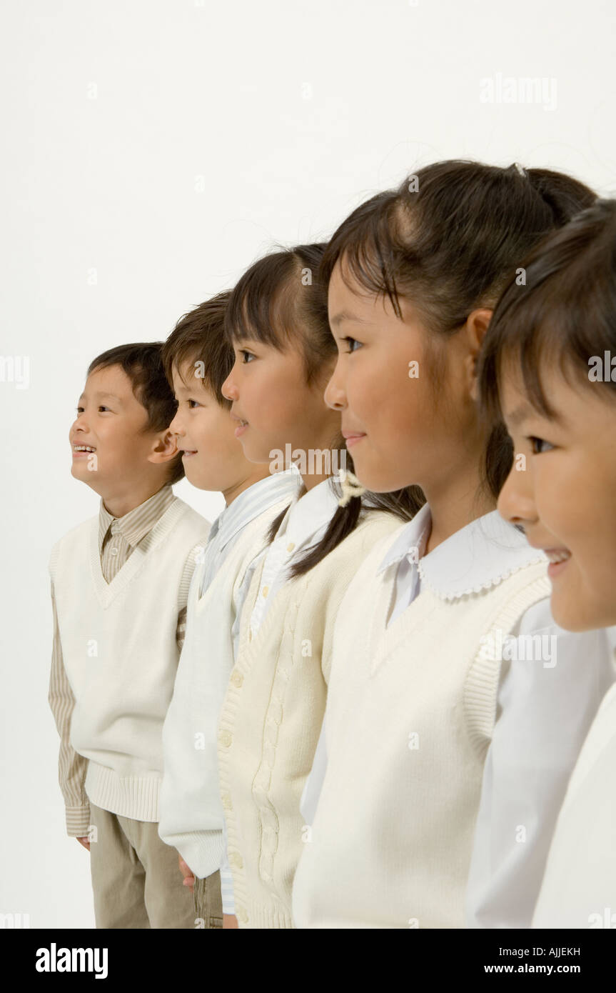 Five elementary age children standing Stock Photo - Alamy