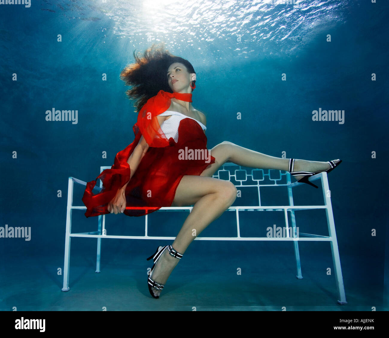 Woman underwater in pool wearing fashion outfit Stock Photo - Alamy