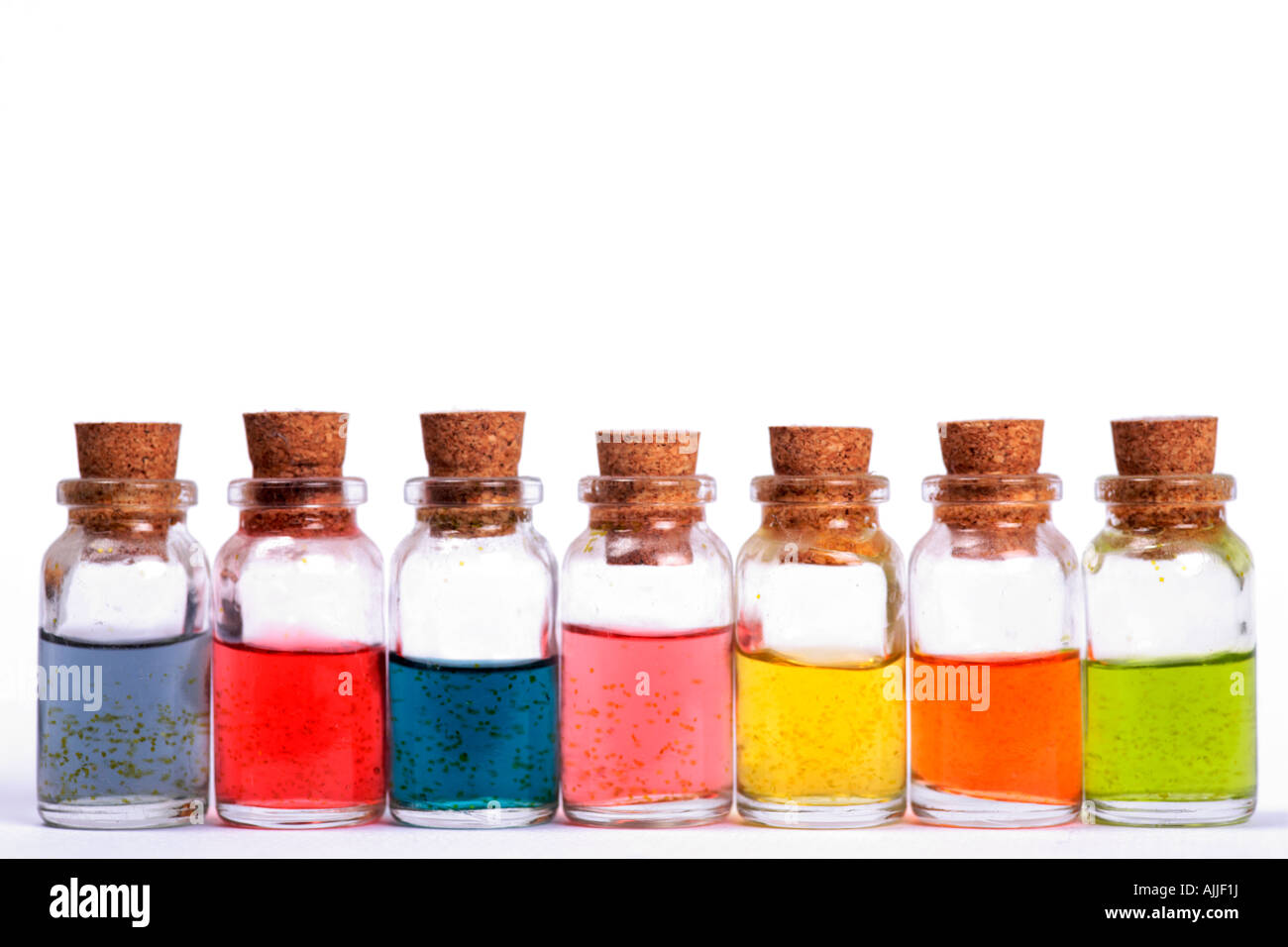 Coloured liquid in small glass jars Stock Photo - Alamy