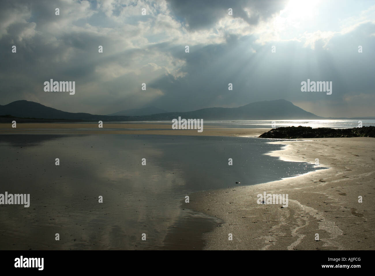 Silver mirror in Donegal under light shafts, Pollan Strand, Isle of ...