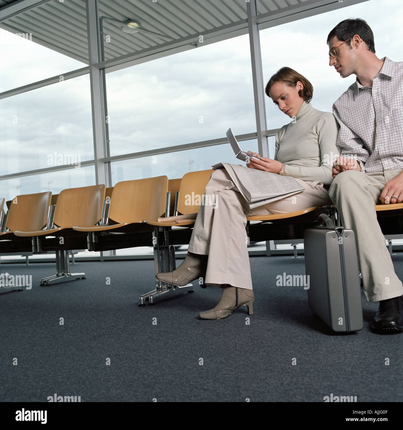 Two colleagues in a departure lounge Stock Photo - Alamy