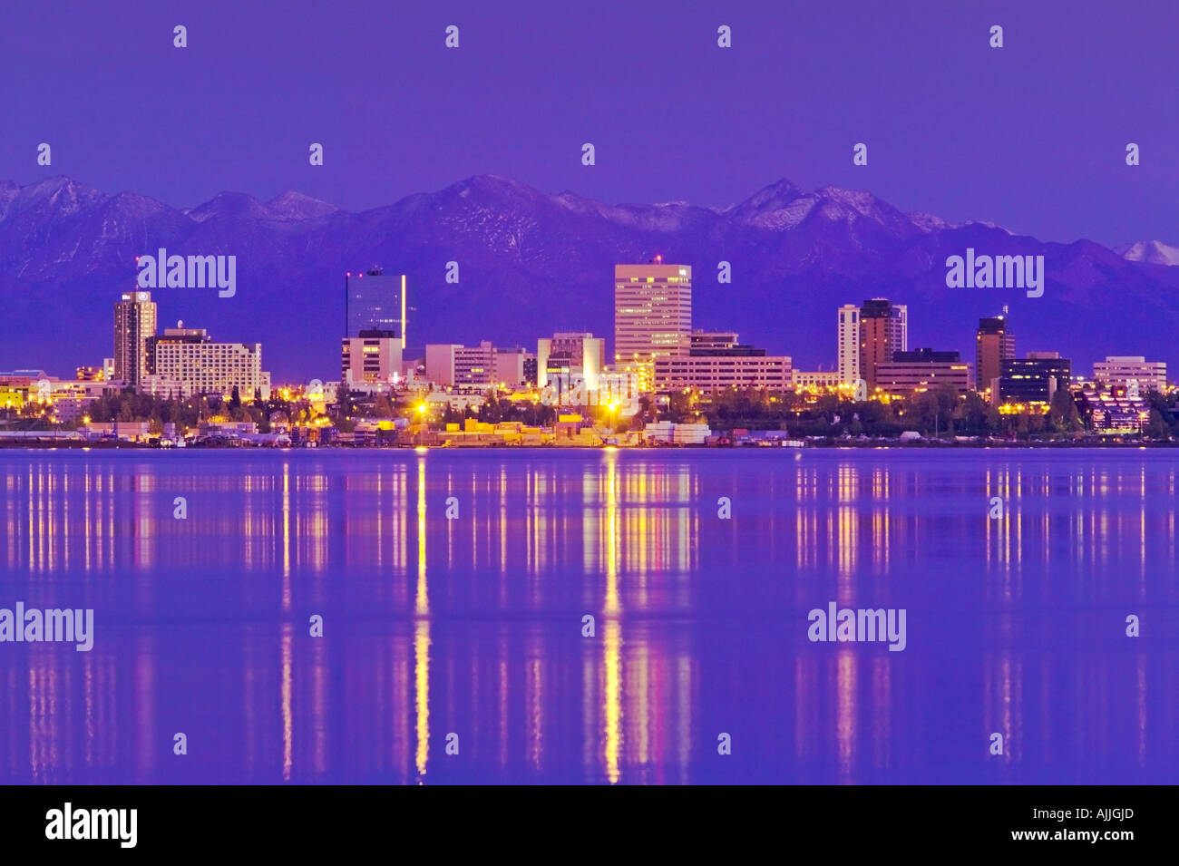 View of Anchorage city lights after sunset across Knik Arm reflections ...