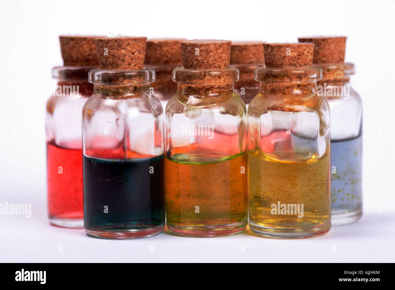 Coloured liquid in small glass jars Stock Photo - Alamy