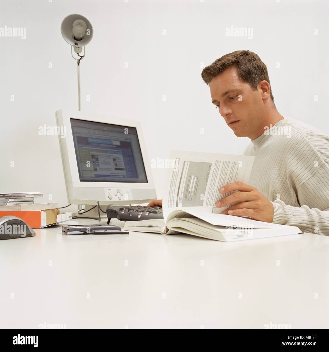 Office worker reading a book Stock Photo - Alamy