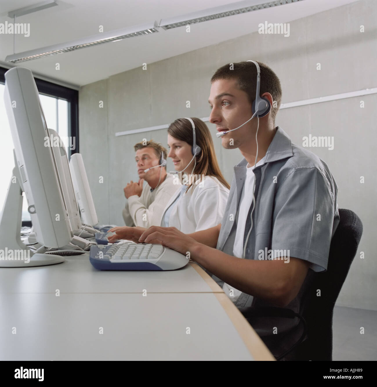 Three call centre operators Stock Photo - Alamy
