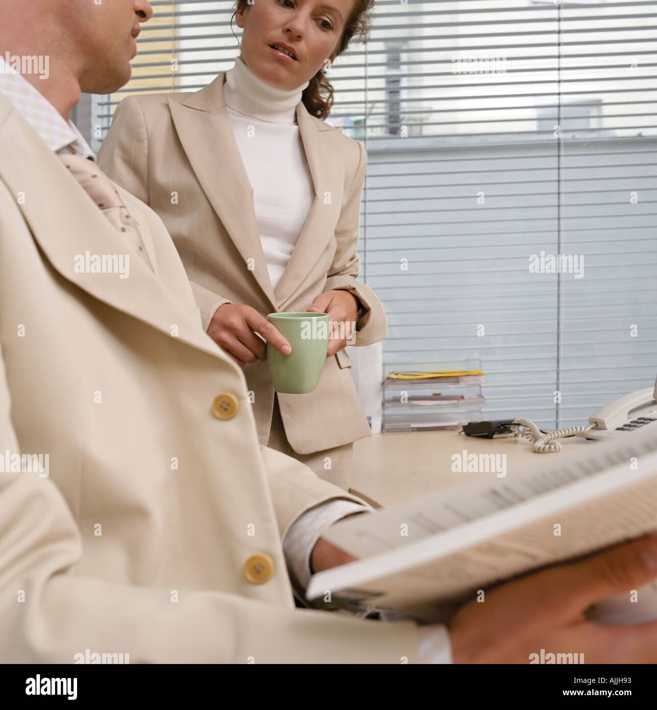 Office workers reading book Stock Photo - Alamy