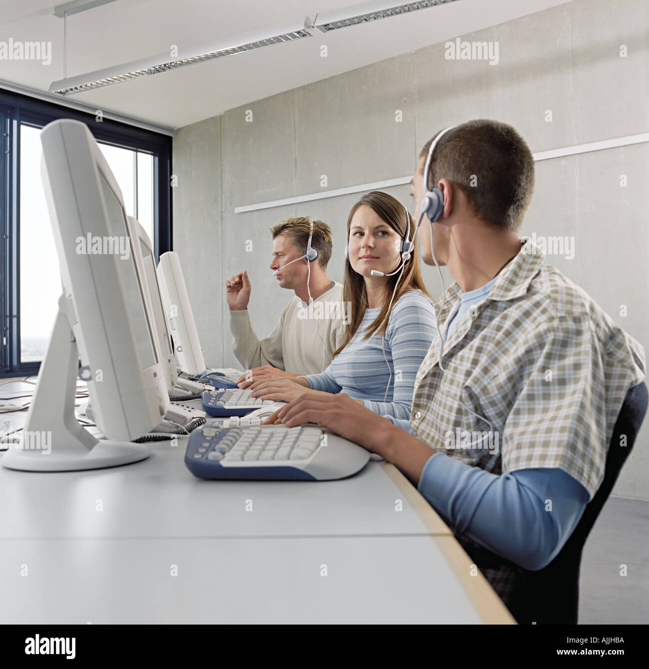 Three call centre operators Stock Photo - Alamy