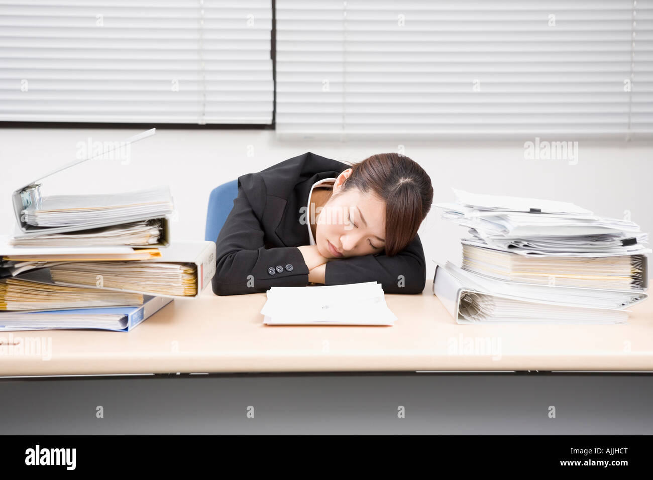 Young woman sleeping at desk Stock Photo - Alamy