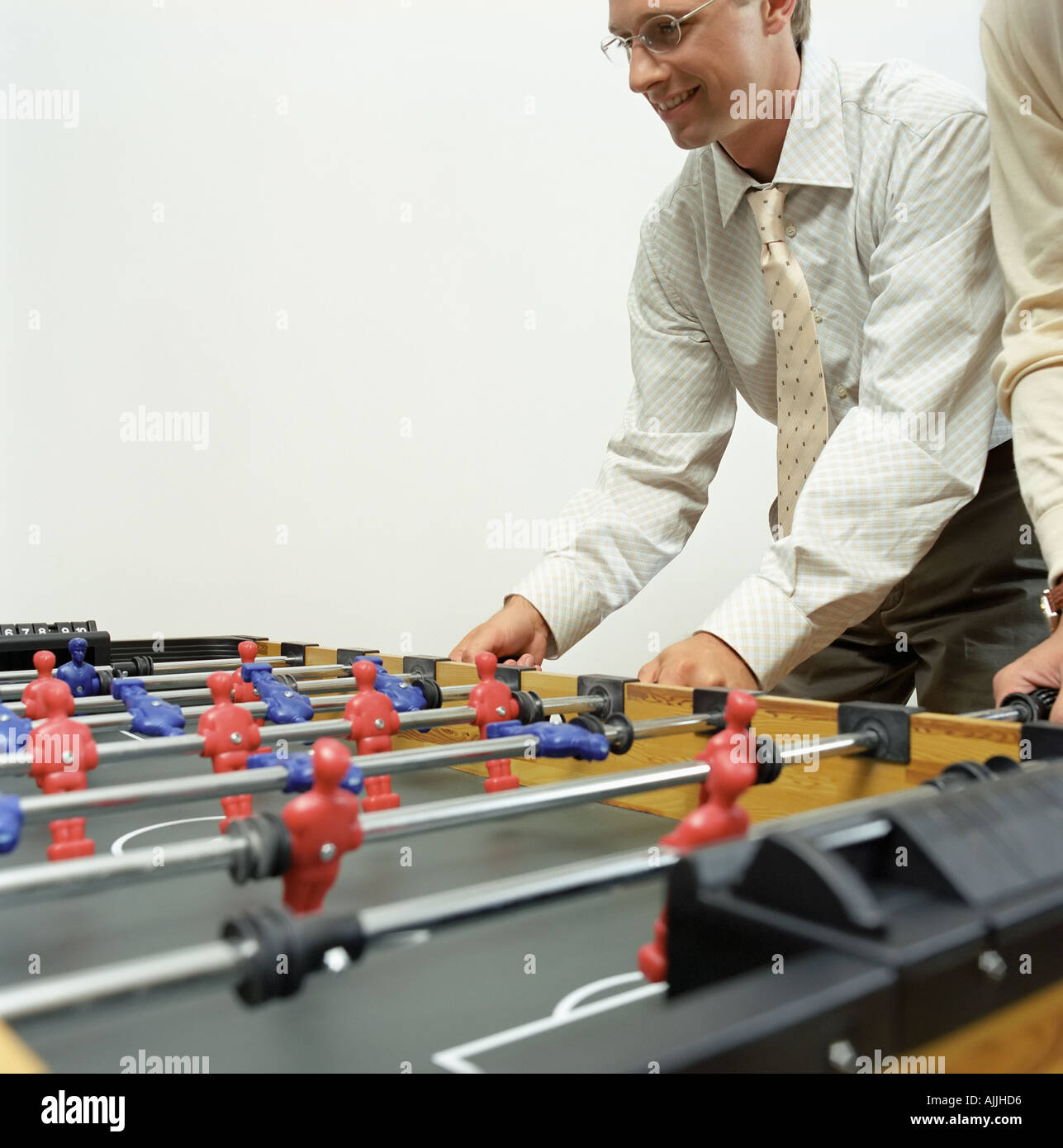 Businessmen playing table football Stock Photo - Alamy