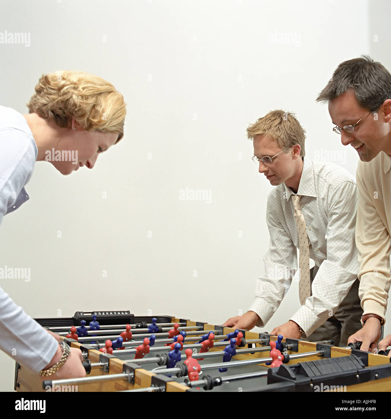 Office workers playing table football Stock Photo - Alamy