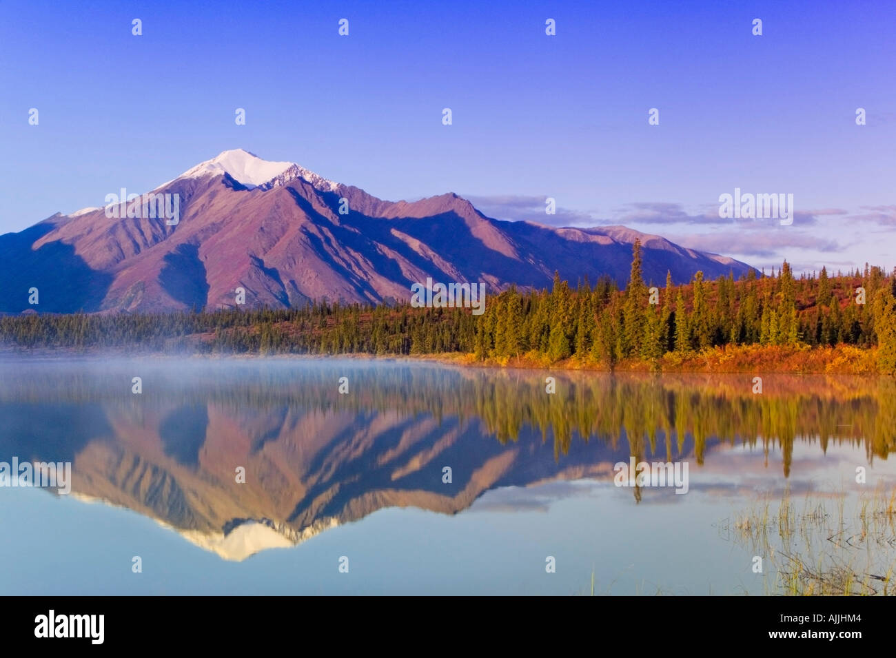 Mountains reflect in Drashner Lake just off the Denali Highway ...