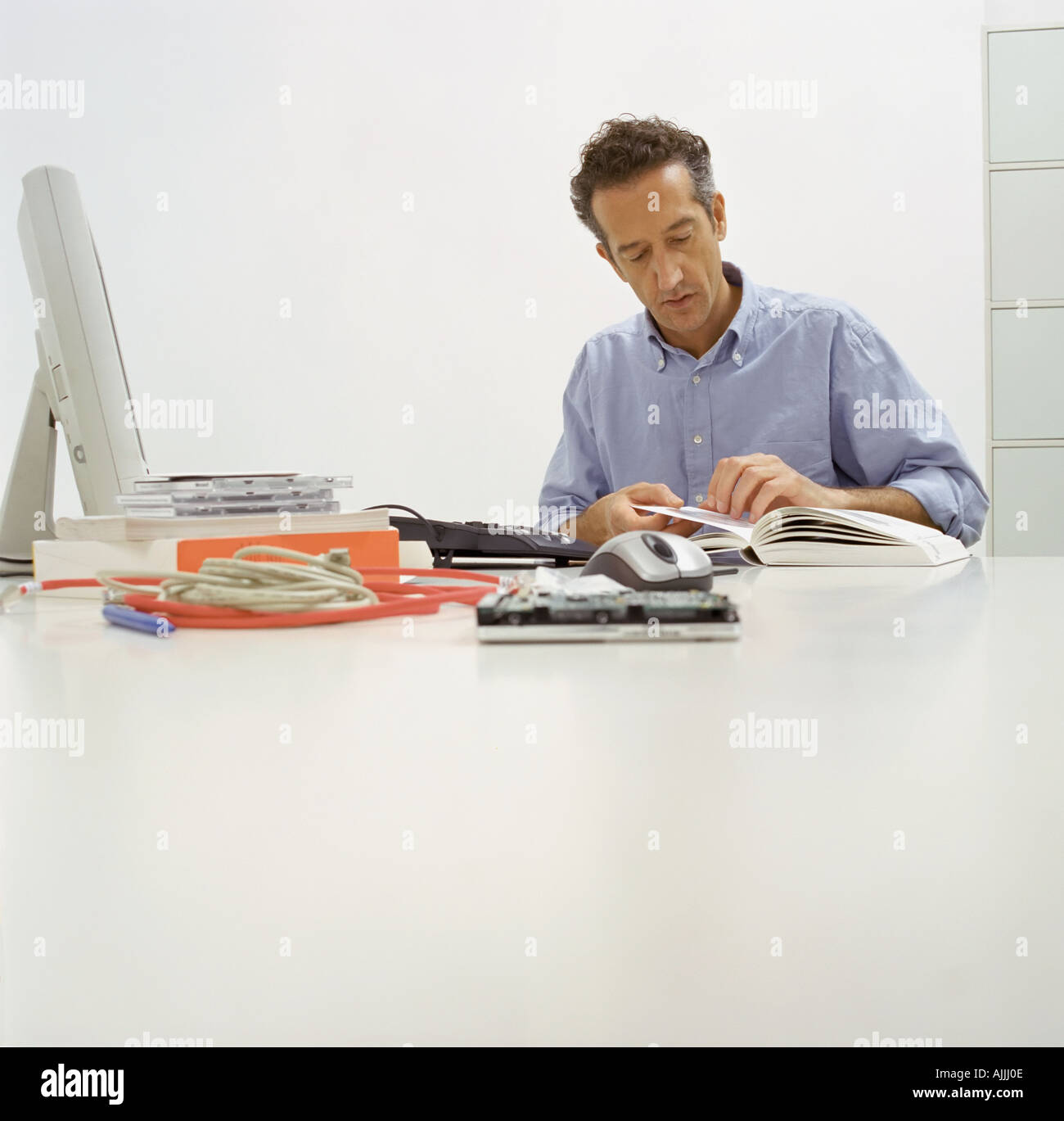 Office worker reading a book Stock Photo - Alamy