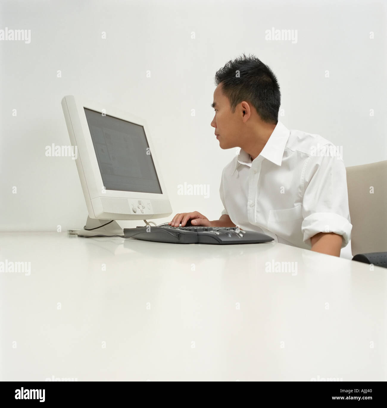 Office worker using computer Stock Photo - Alamy
