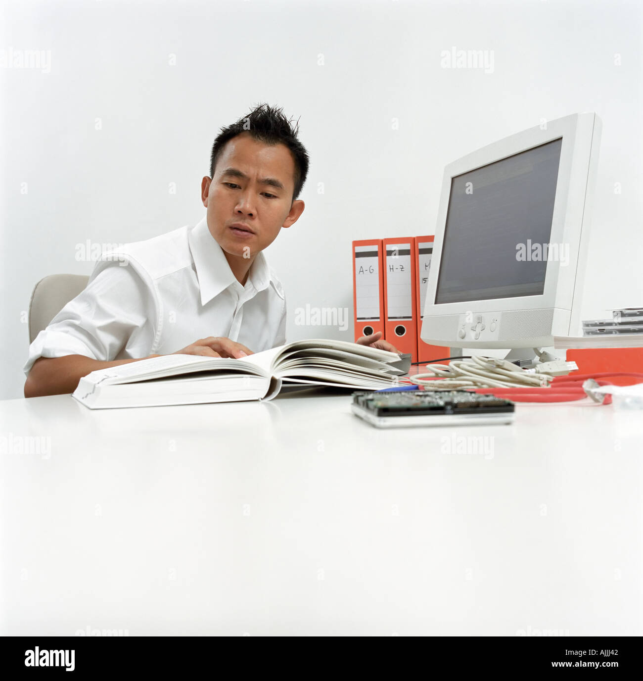 Office worker reading a book Stock Photo - Alamy