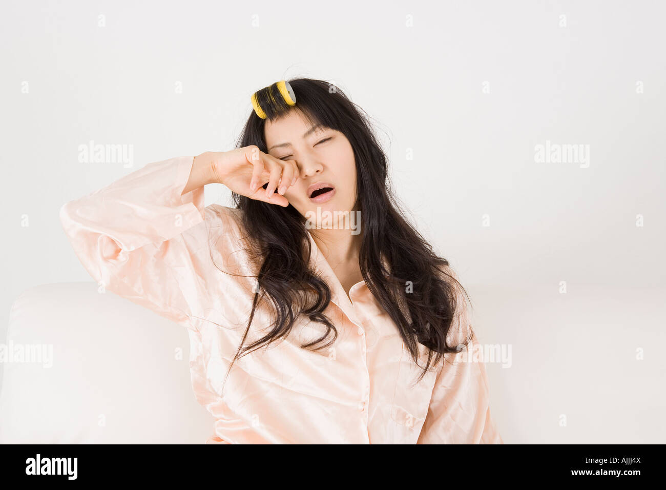 Young woman waking up Stock Photo - Alamy