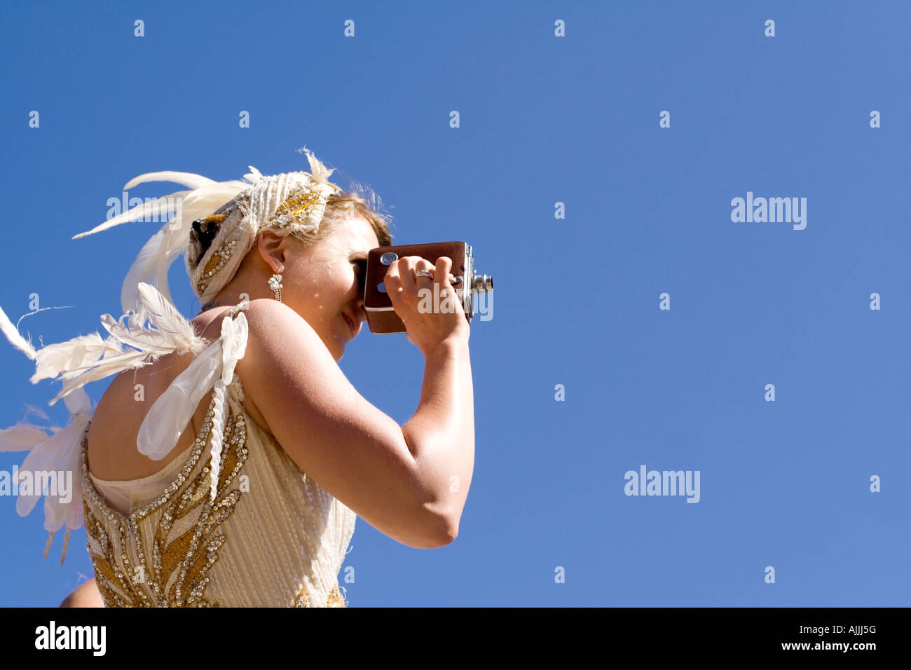 Pretty flapper girl making a movie using a vintage camera Stock Photo ...
