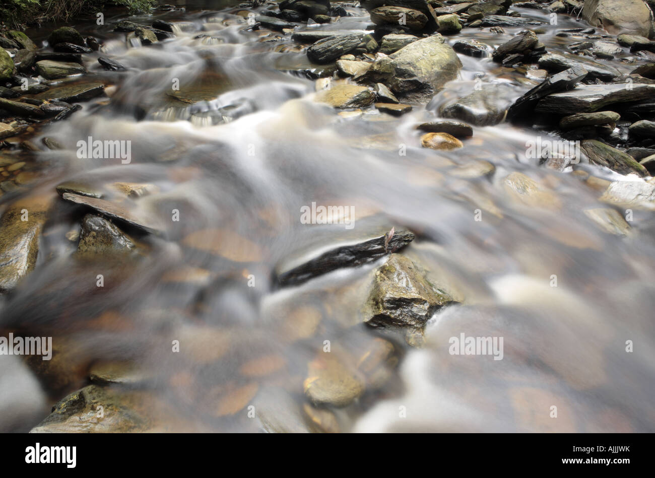 Water flowing over rocks in river Stock Photo - Alamy