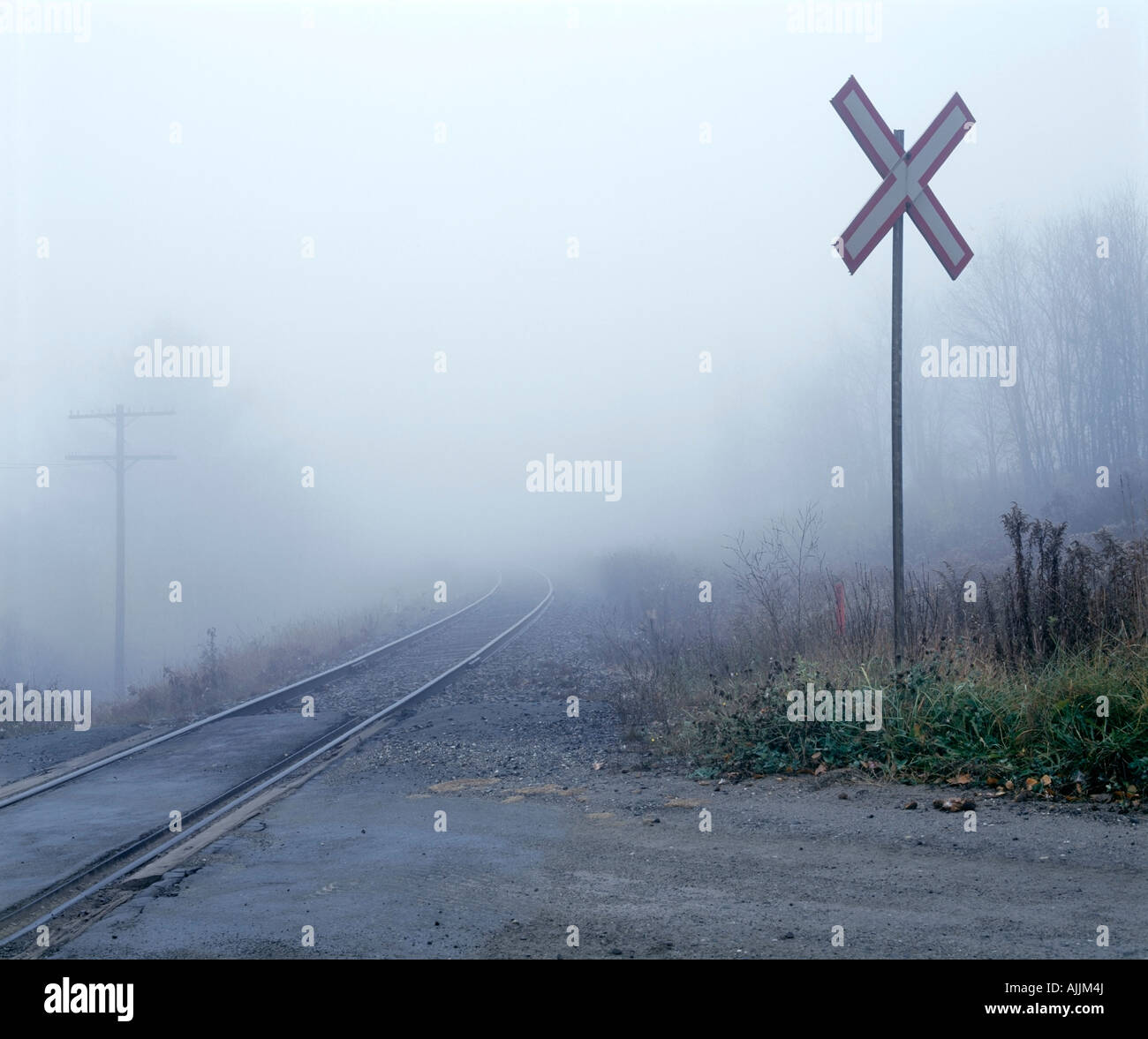 Railway crossing in the fog Stock Photo - Alamy