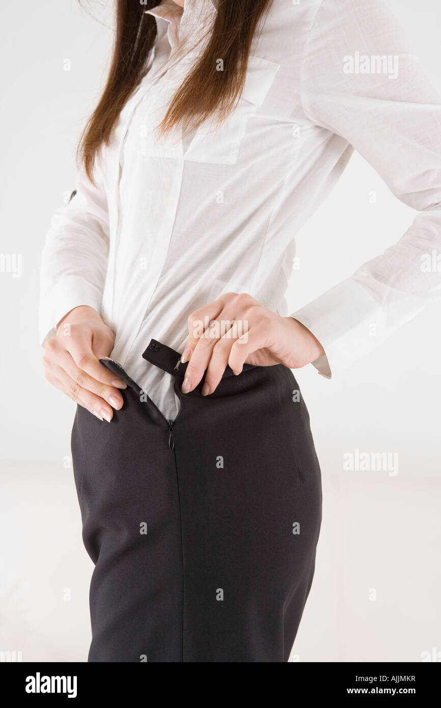 Young woman getting dressed Stock Photo - Alamy