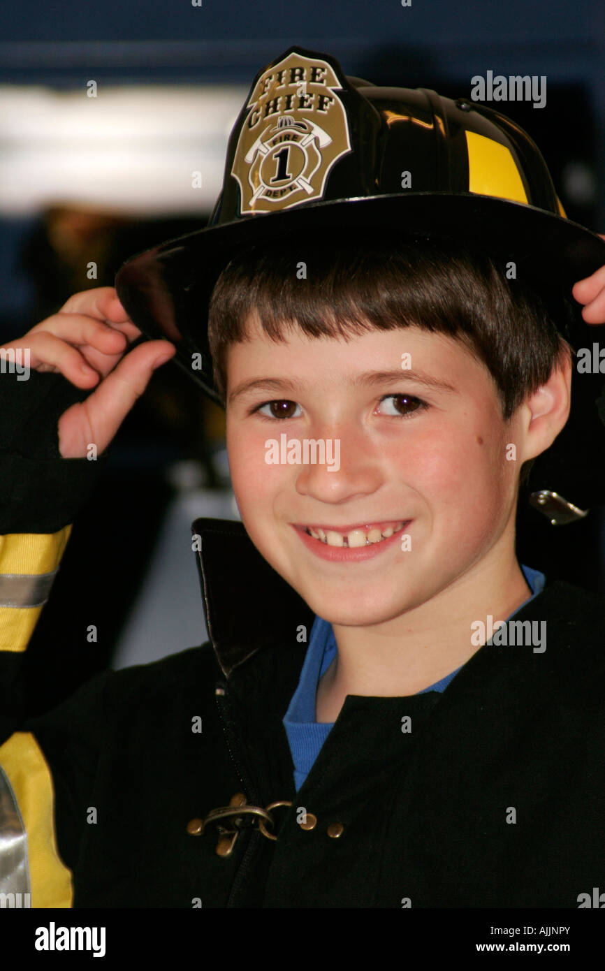 Boy Fire Fighter at a Fire Fair dressed up in a uniform as a Fire Chief ...