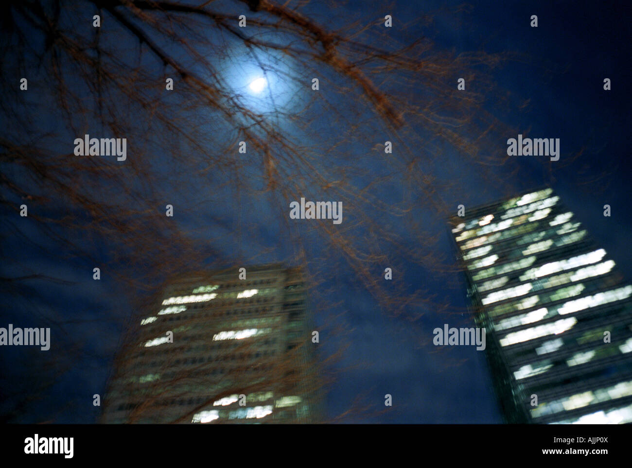 Nighttime stroll past Twin Buildings, darkly and sparsely lit, with a ...