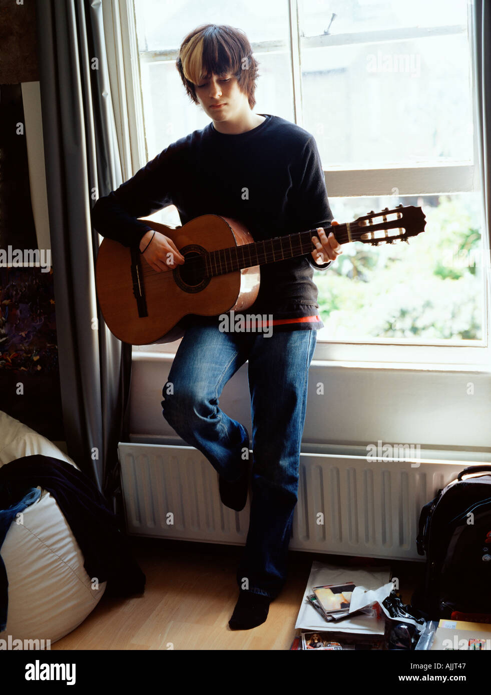 Boy playing acoustic guitar Stock Photo - Alamy