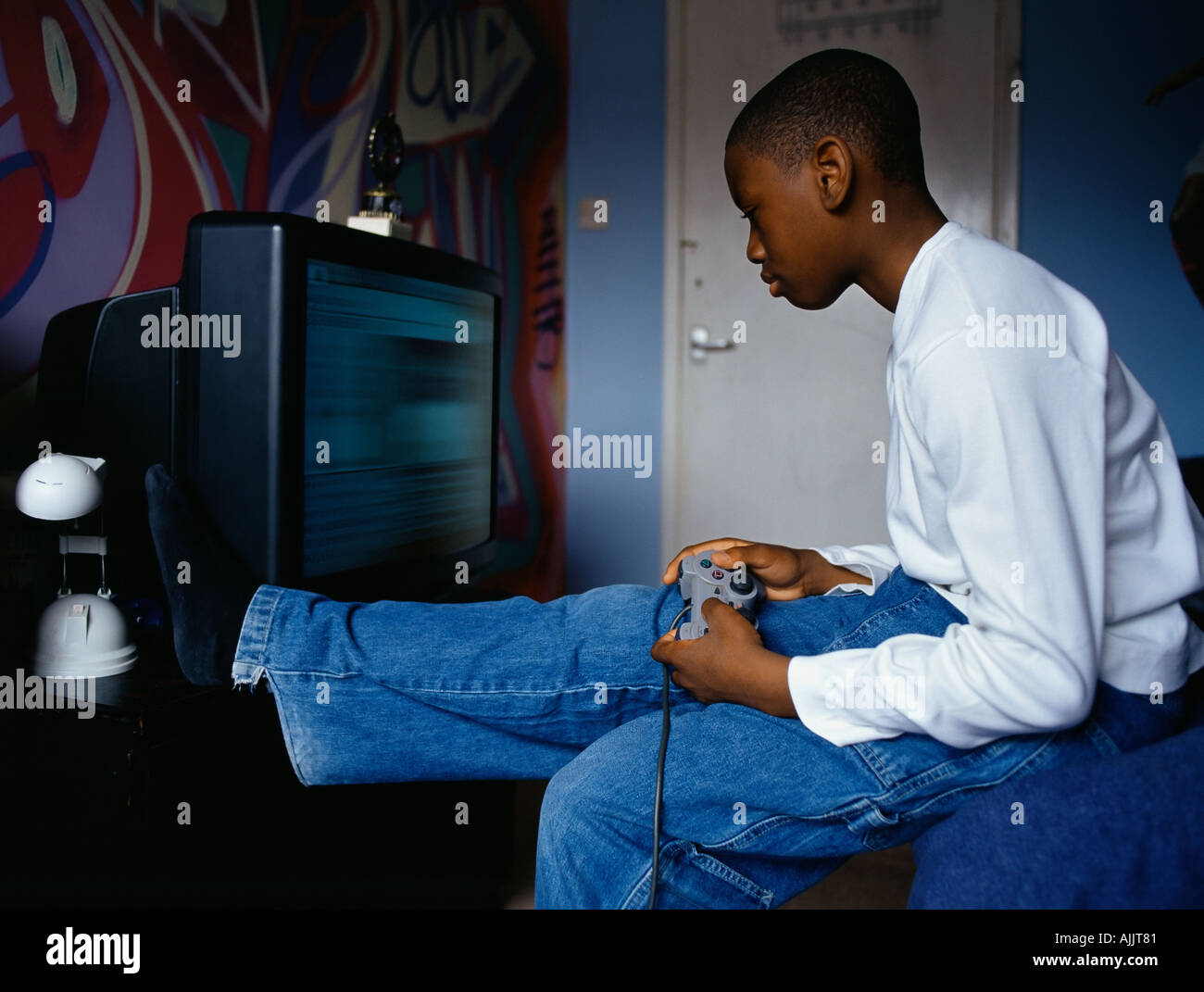 Boy playing a video game Stock Photo - Alamy
