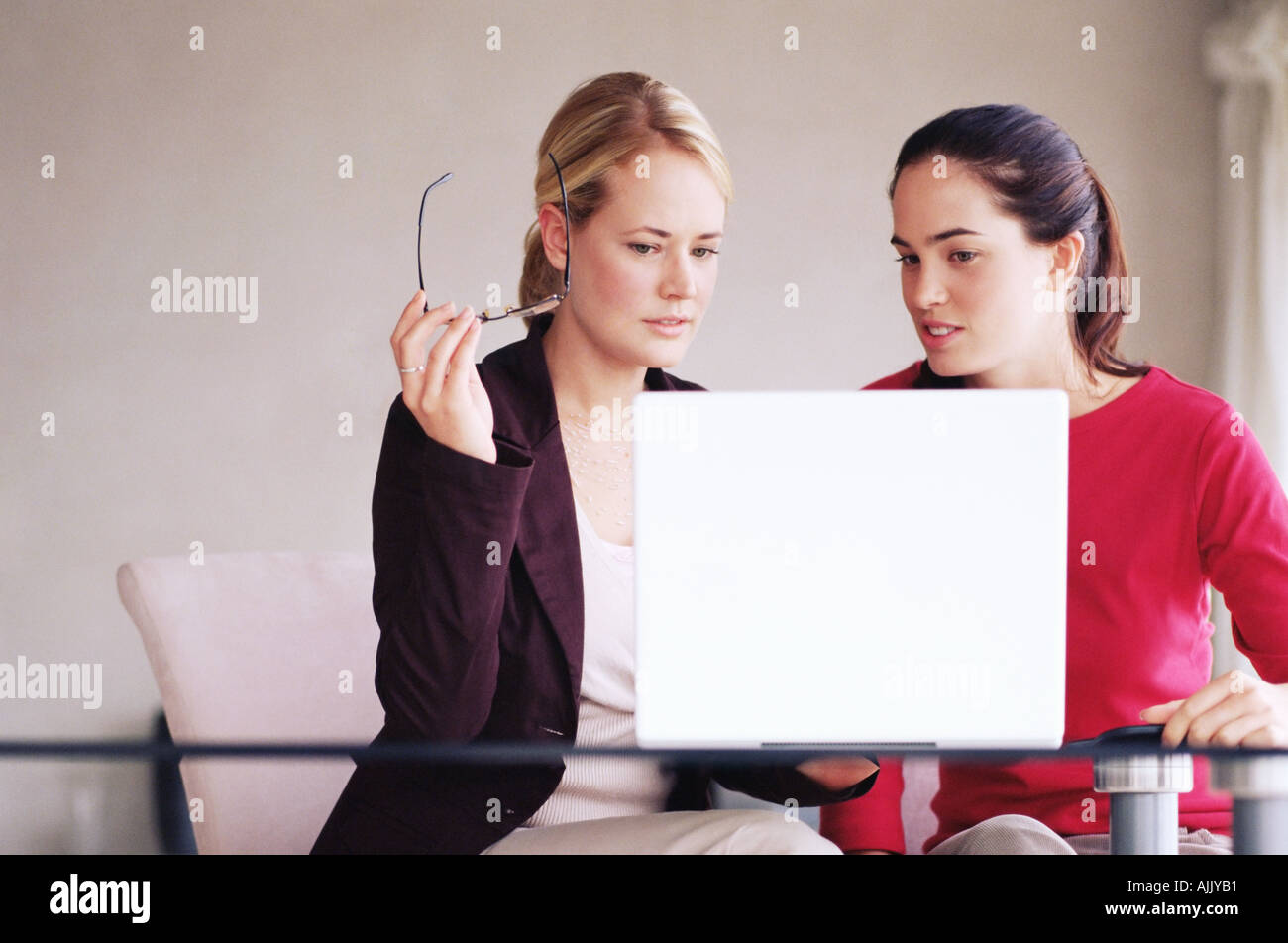 Two women using laptop computer Stock Photo - Alamy