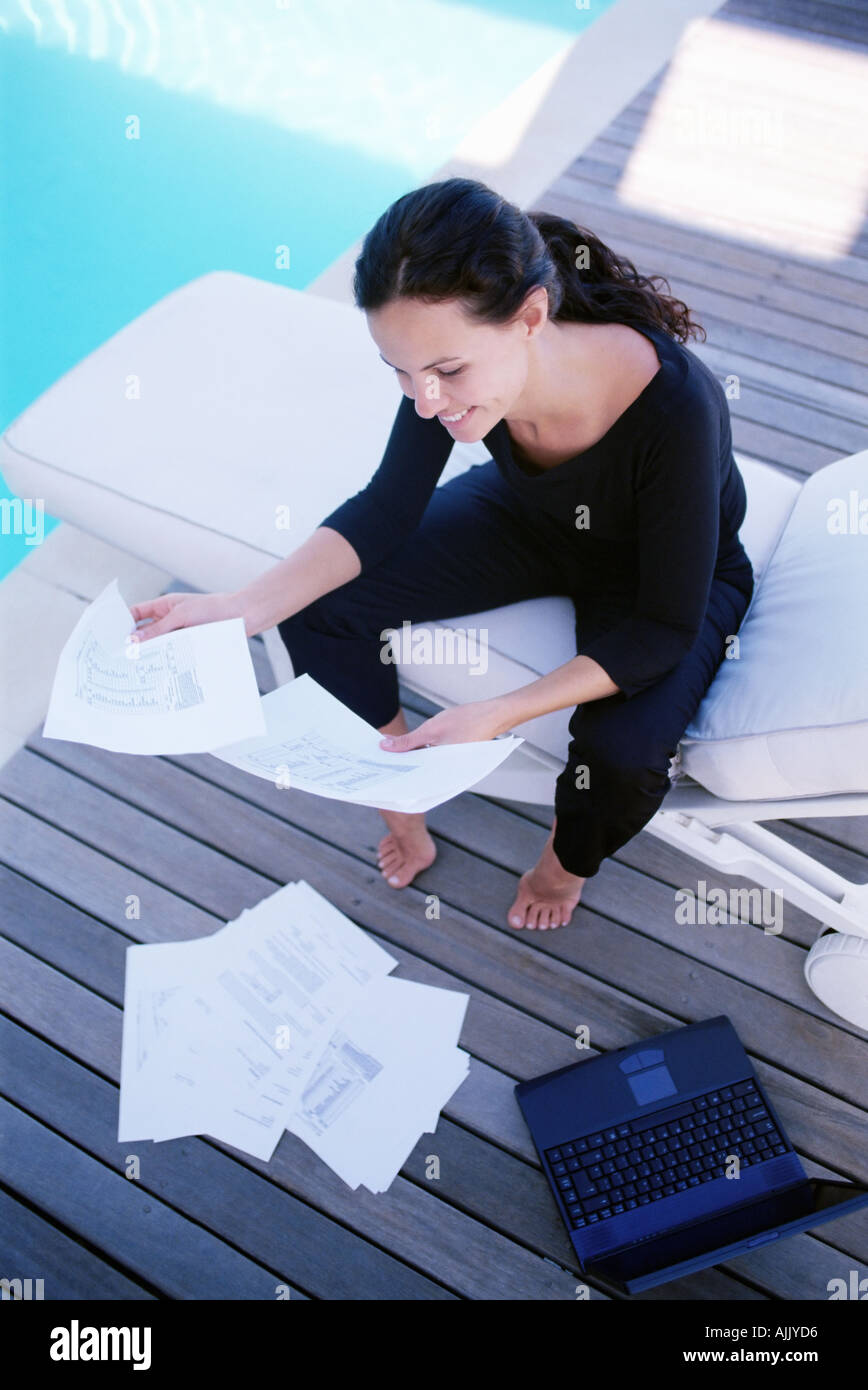 Woman working by the pool Stock Photo - Alamy