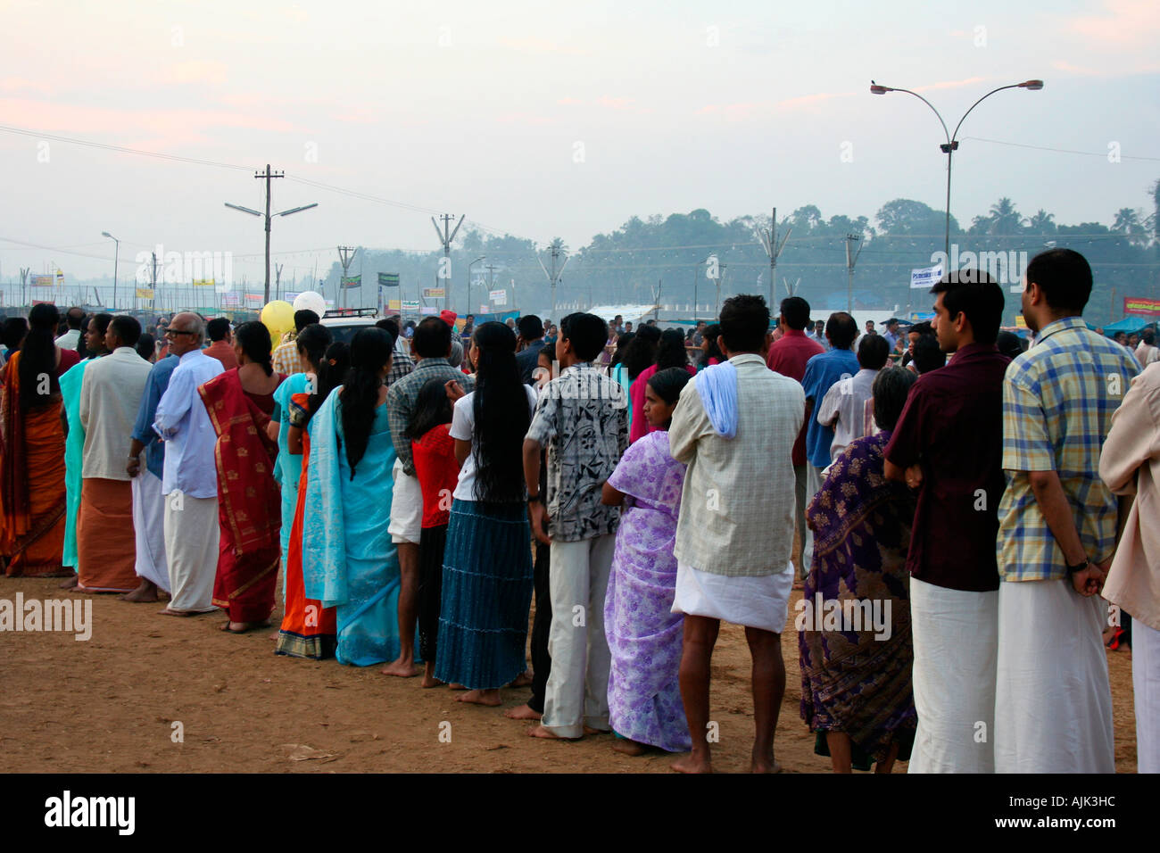 Devotees waiting for darshan at the farthest end of a queue outside a ...