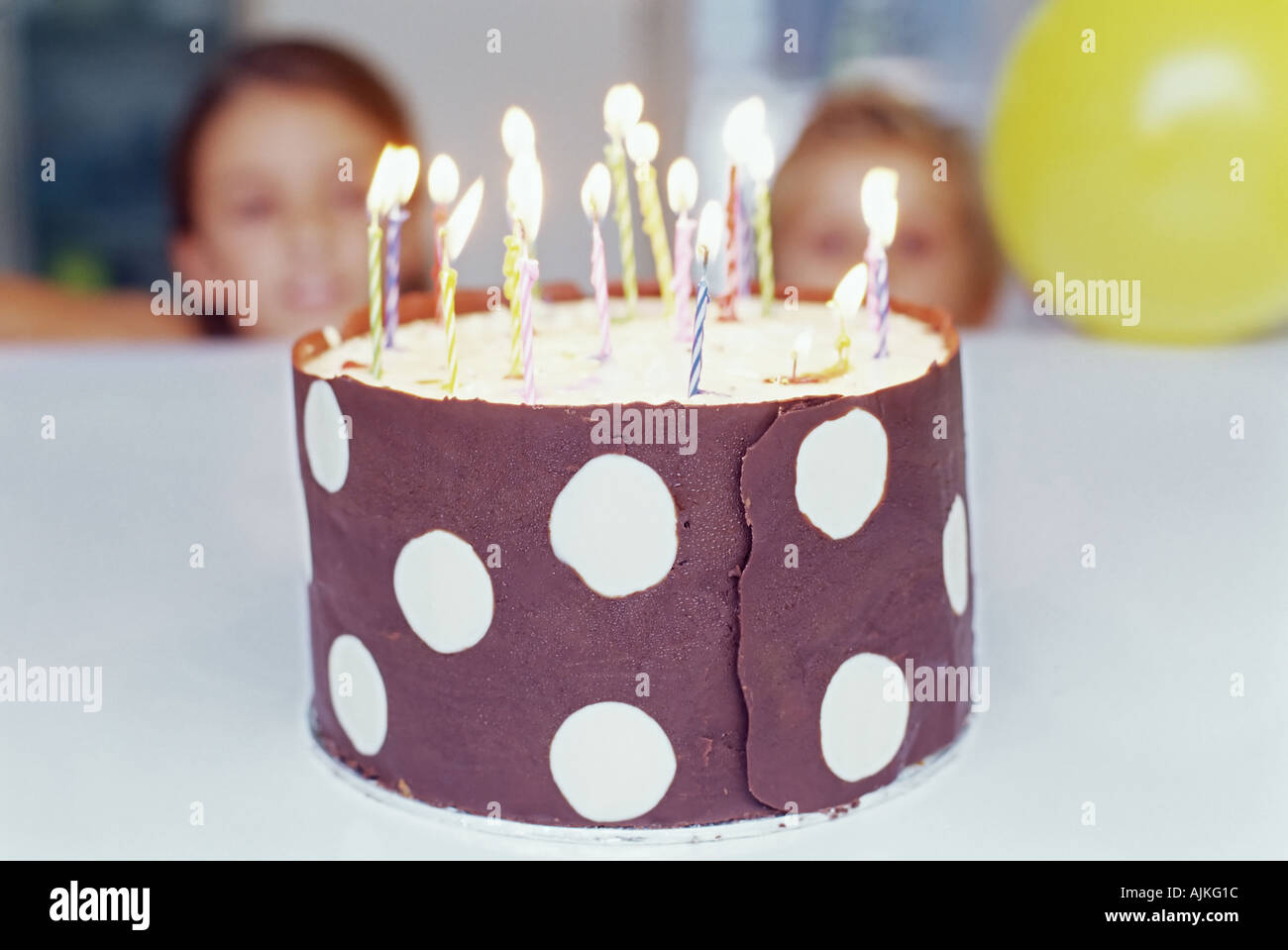 Children looking at birthday cake Stock Photo - Alamy