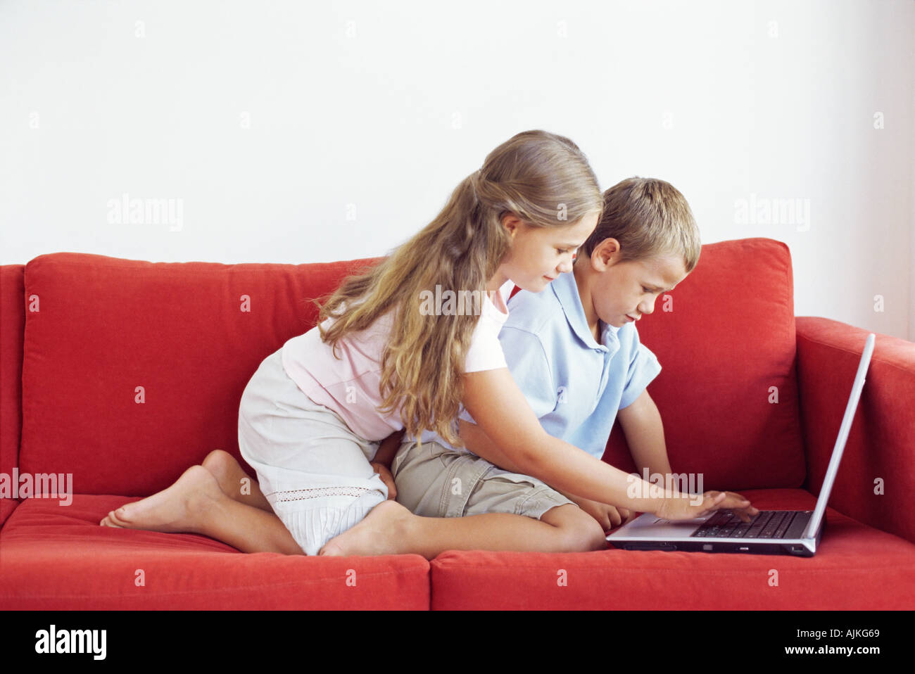 Brother and sister using laptop Stock Photo - Alamy