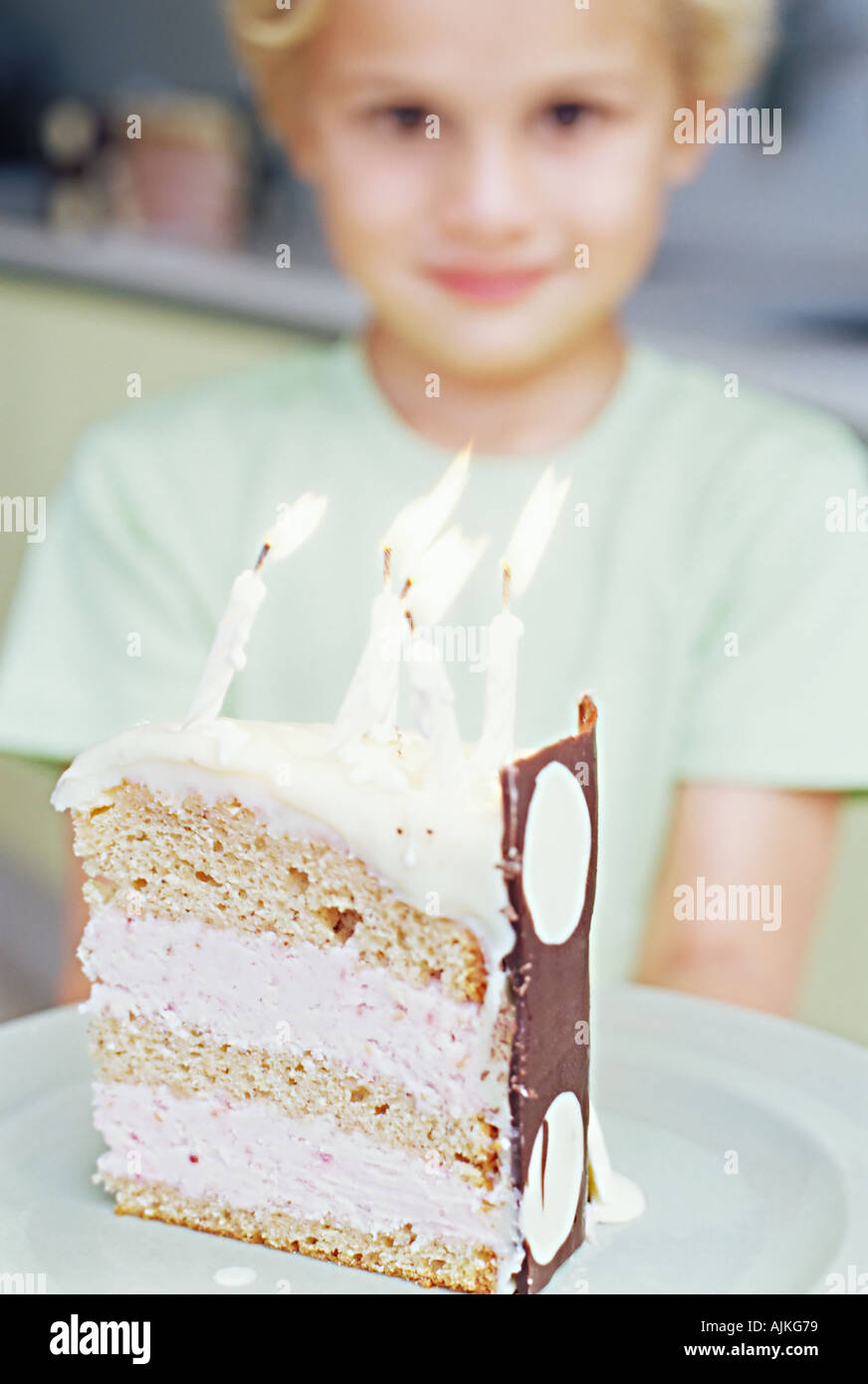 Boy with slice of birthday cake Stock Photo - Alamy