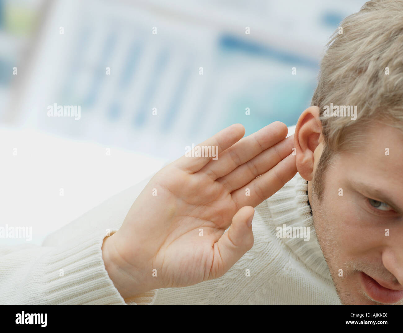 Man putting his hand to his ear Stock Photo - Alamy