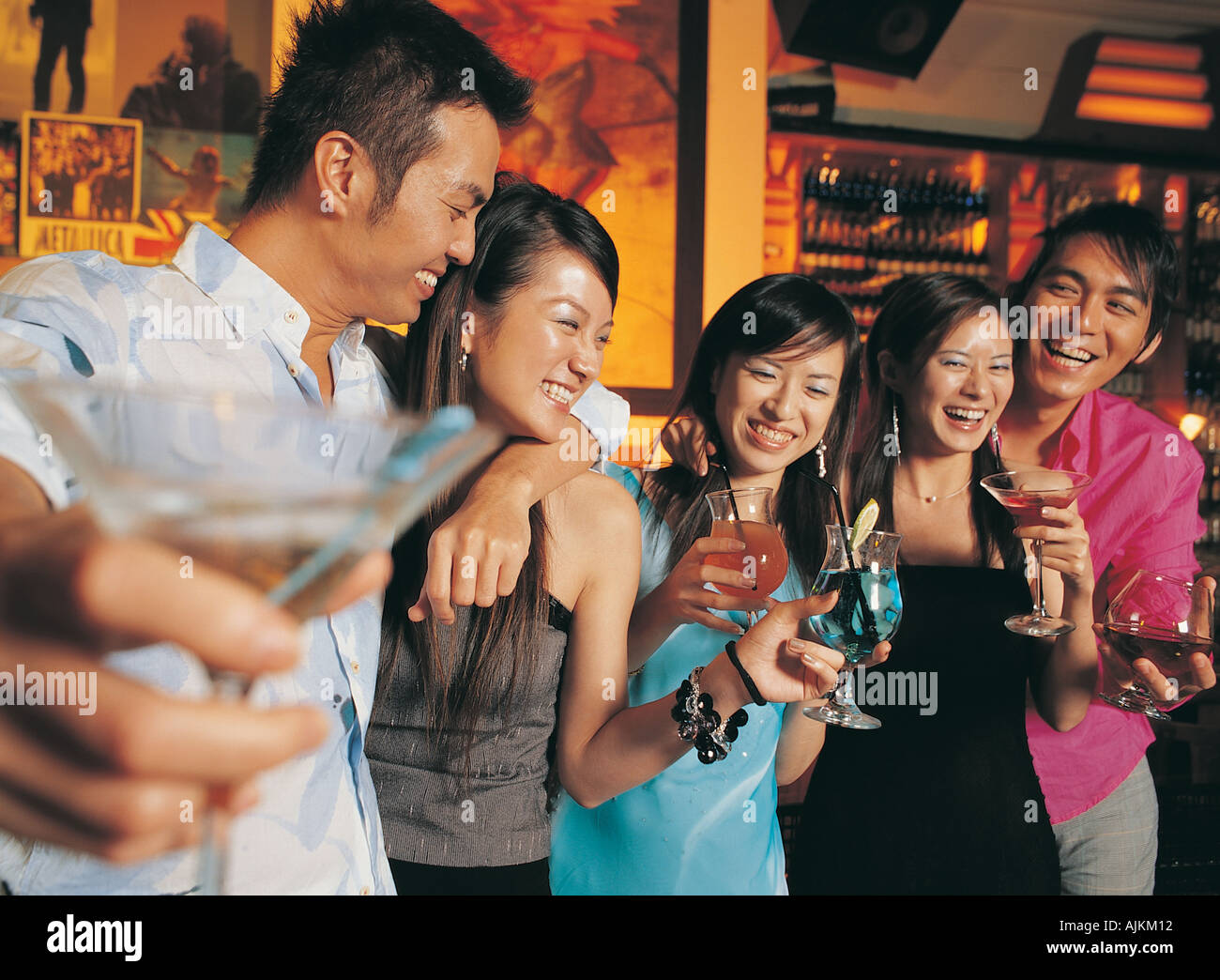 Group of young men and women in a bar Stock Photo - Alamy