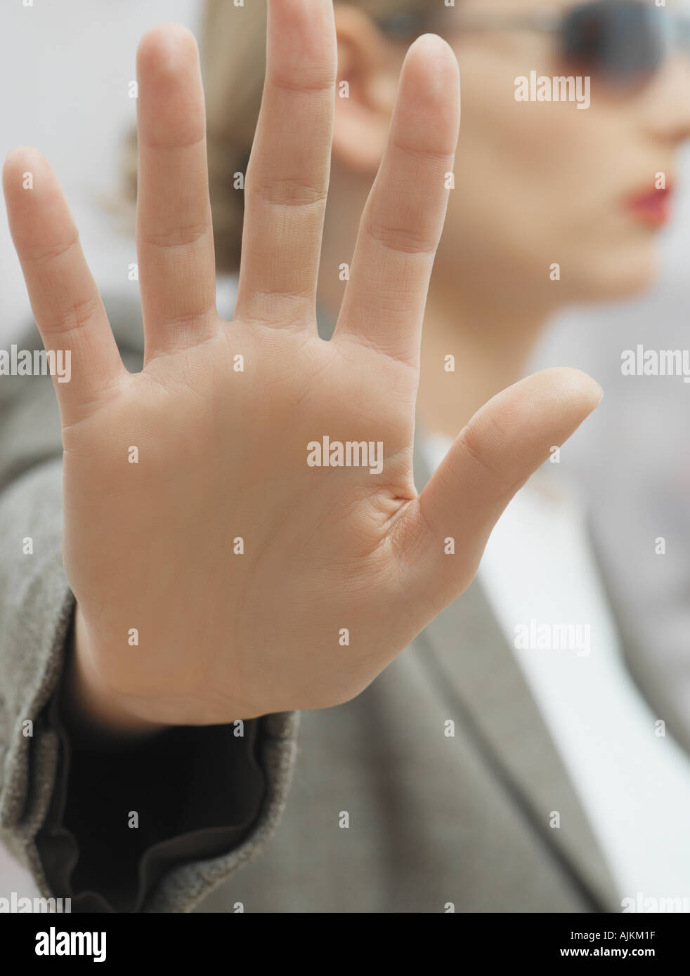 Woman putting her hand up to camera Stock Photo - Alamy