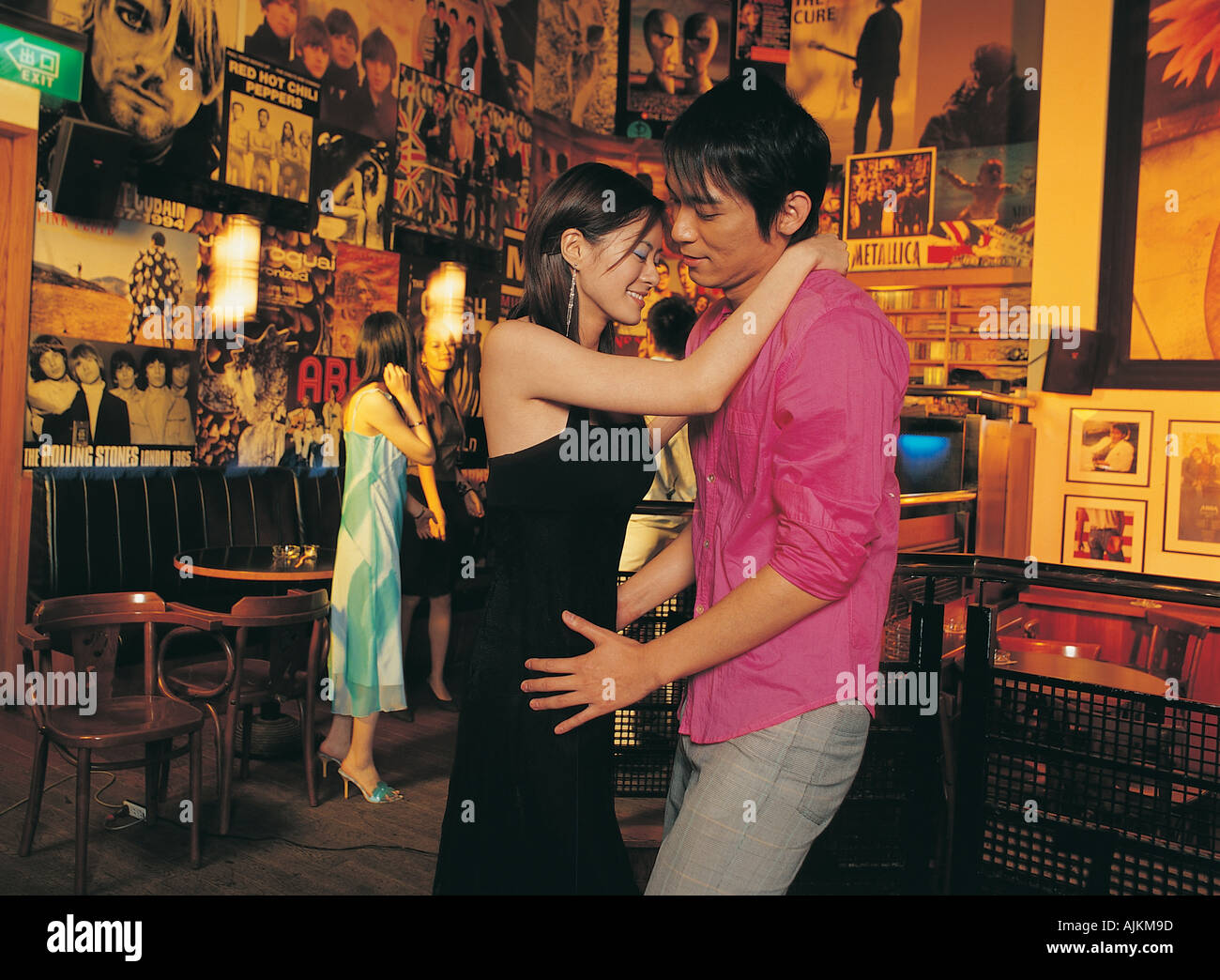 Side profile of a young couple dancing in a bar Stock Photo - Alamy