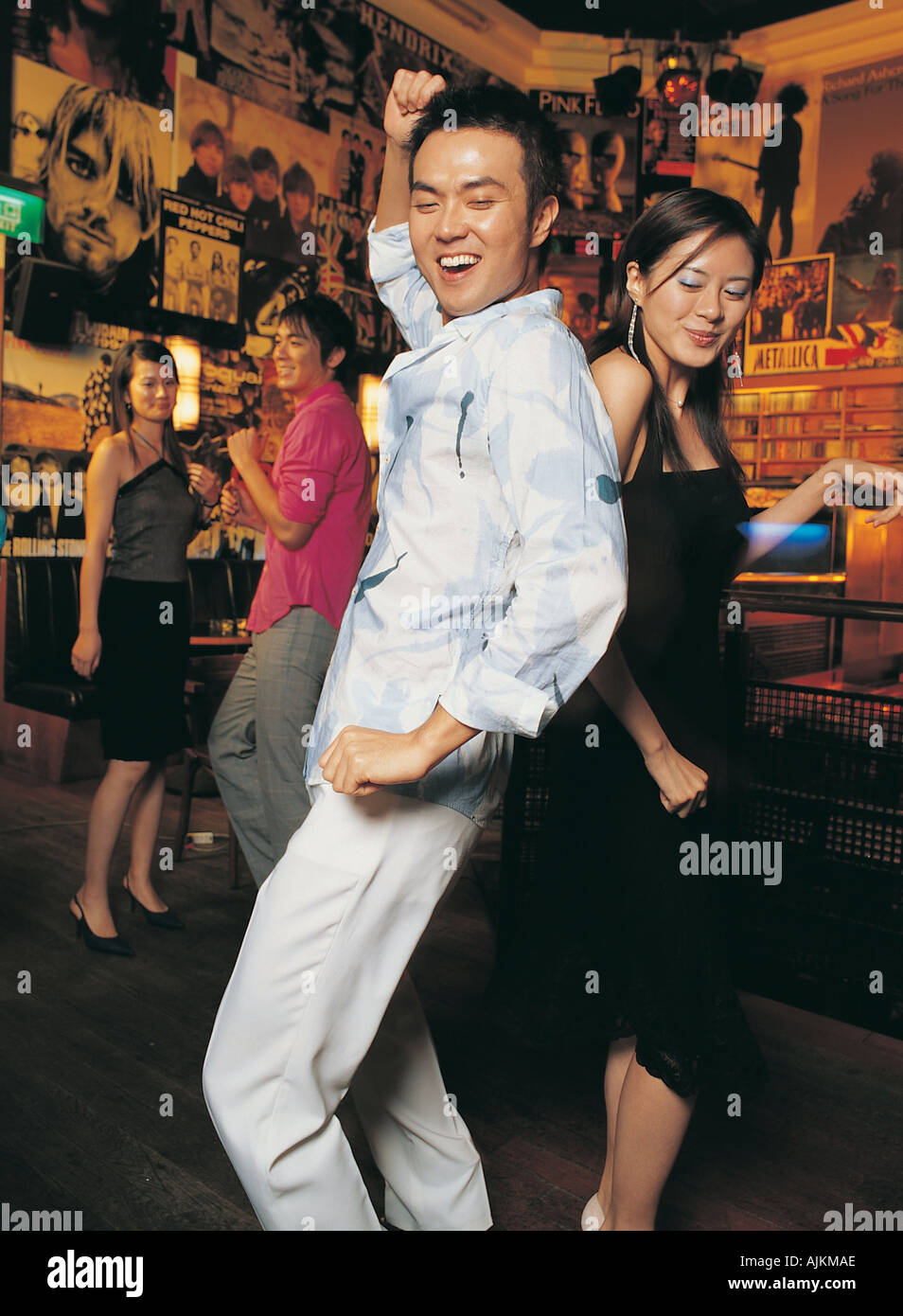 Side profile of a young couple dancing in a bar Stock Photo - Alamy