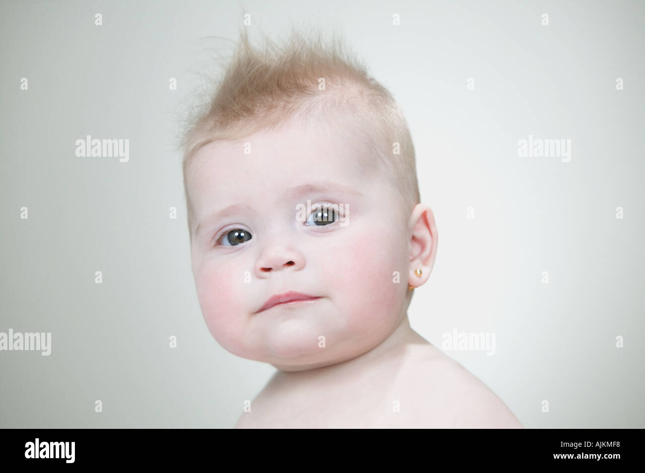 Baby girl with spiked hair Stock Photo - Alamy