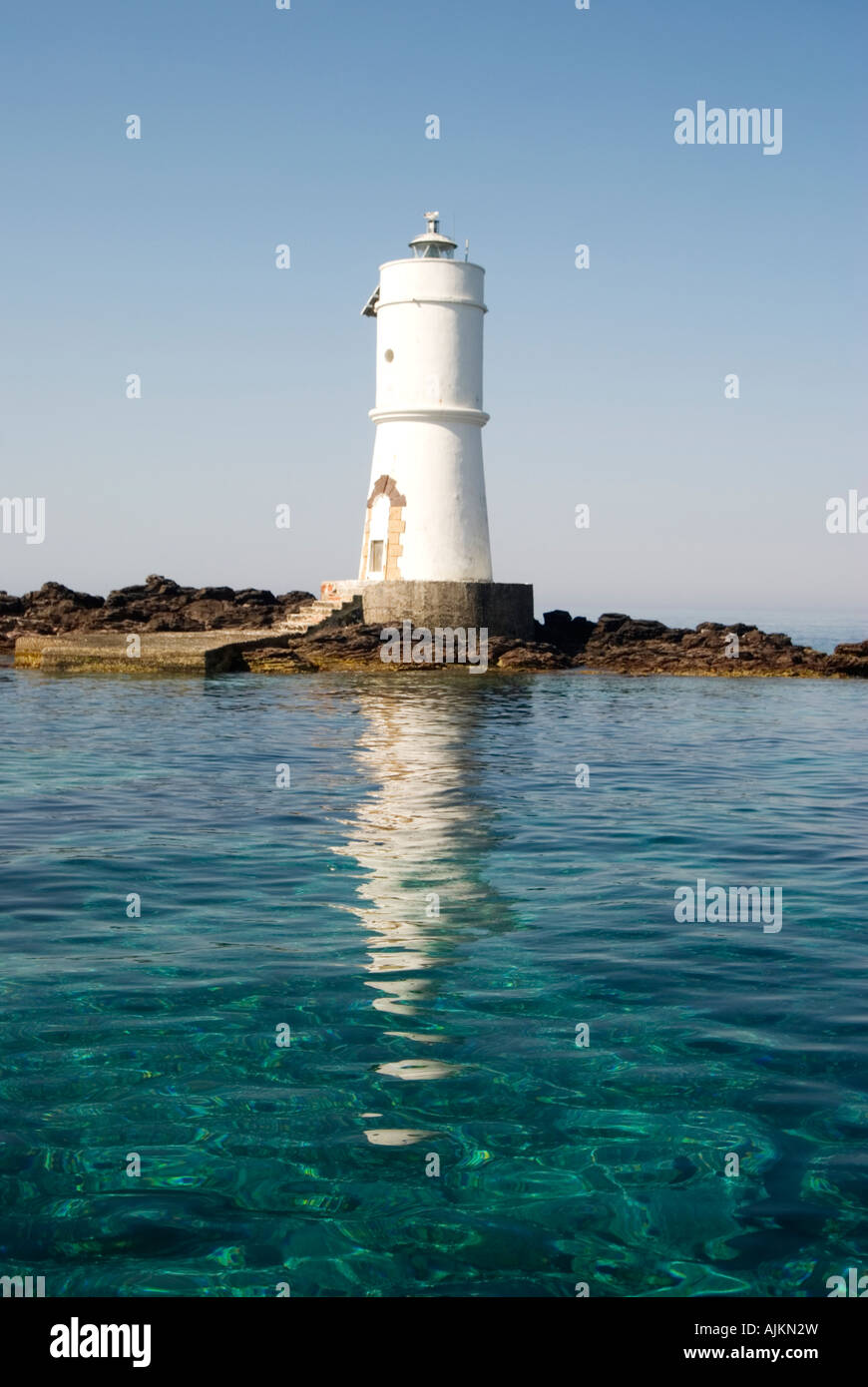 lighthouse in the mediterranean sea with cristal clear water Stock ...