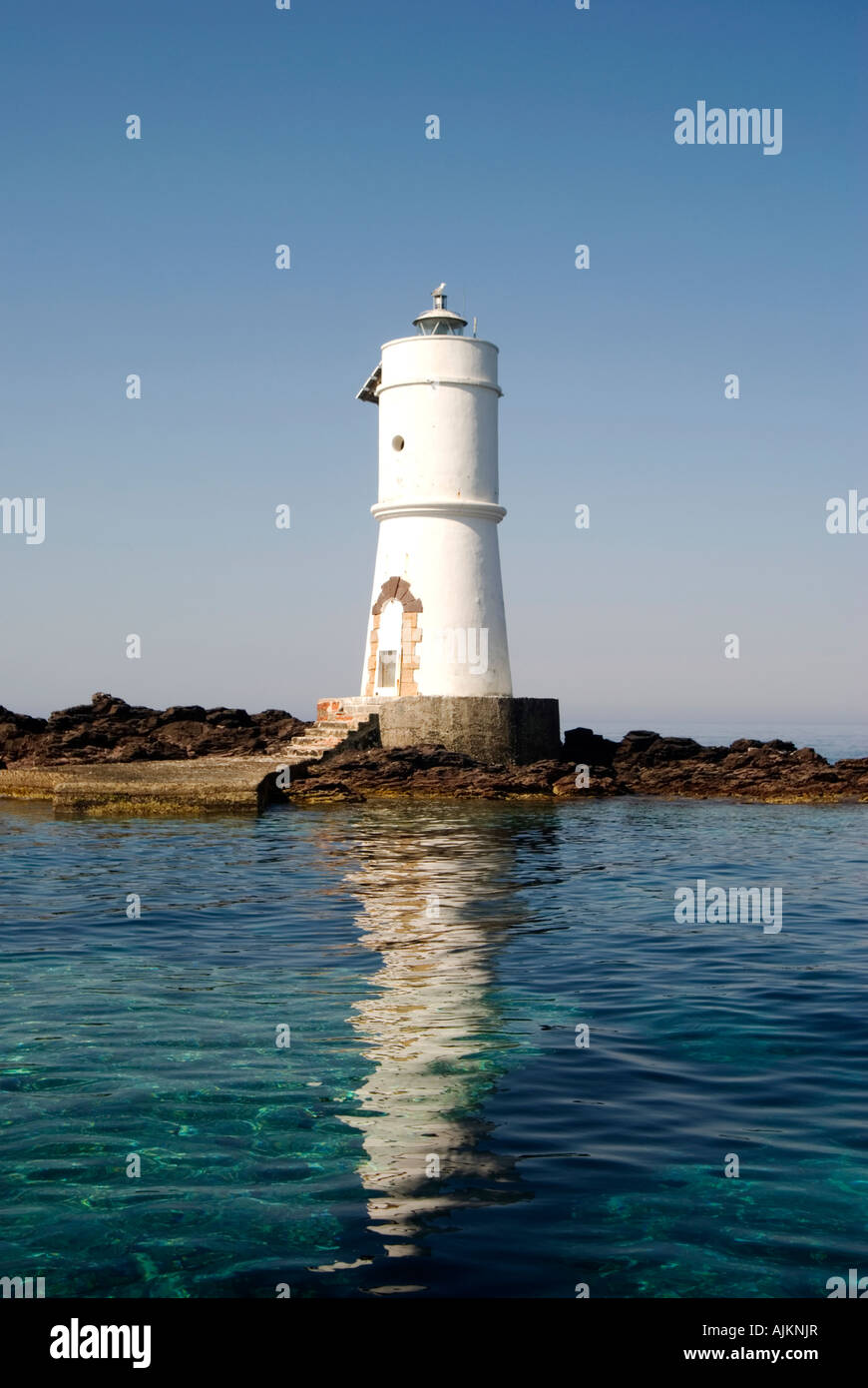 lighthouse in the mediterranean sea with cristal clear water Stock ...