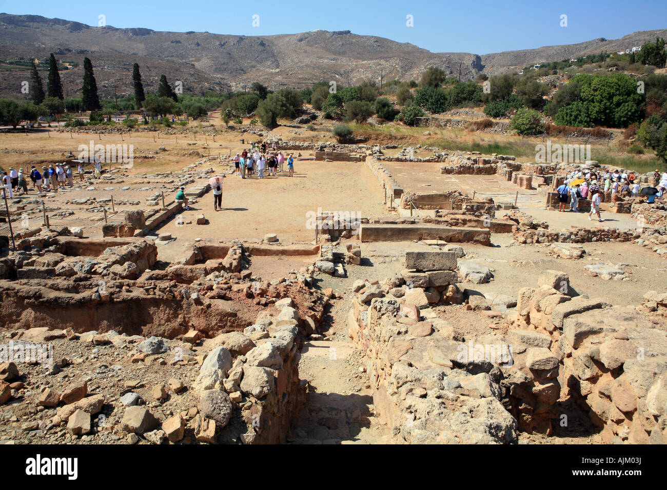 Tourists view the remains of the Minoan palace at Zakros Crete The view ...