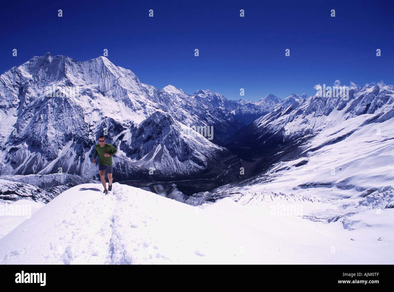 A man running in the Himalaya in Nepal Stock Photo - Alamy
