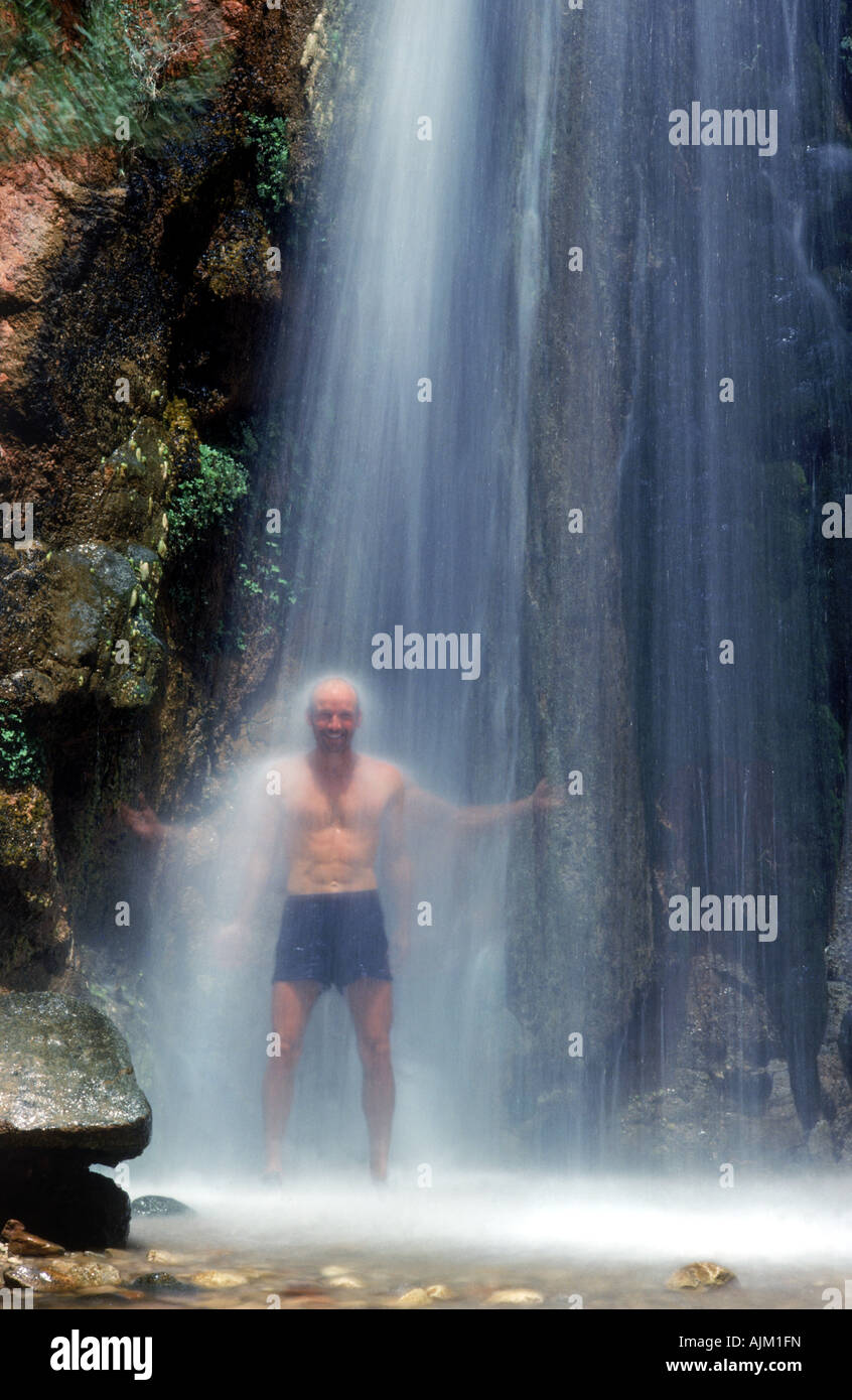 Person standing waterfall hi-res stock photography and images - Alamy