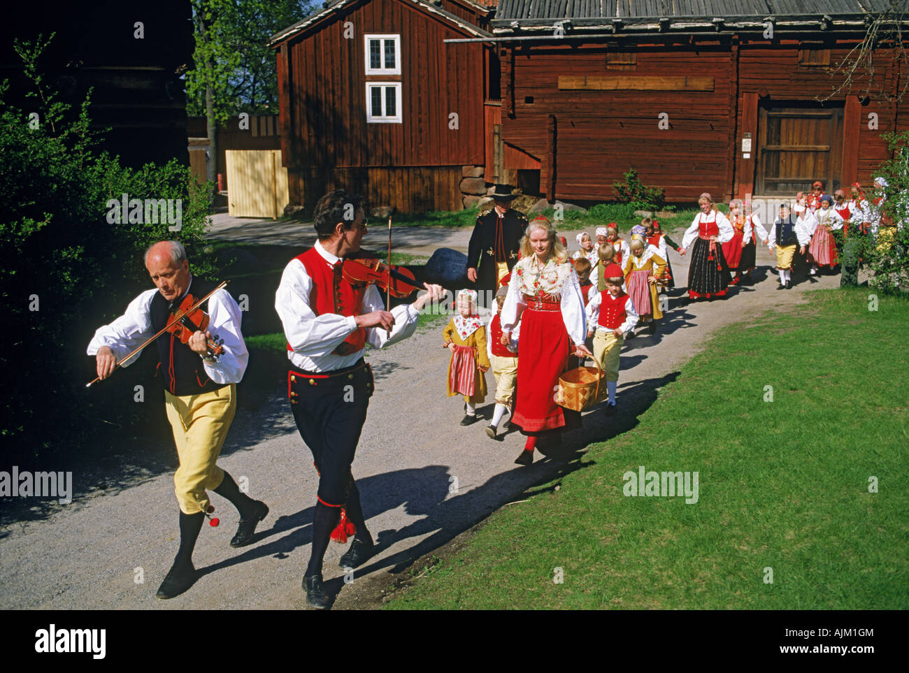 Swedish children and musicians in traditional Midsummer dress at ...