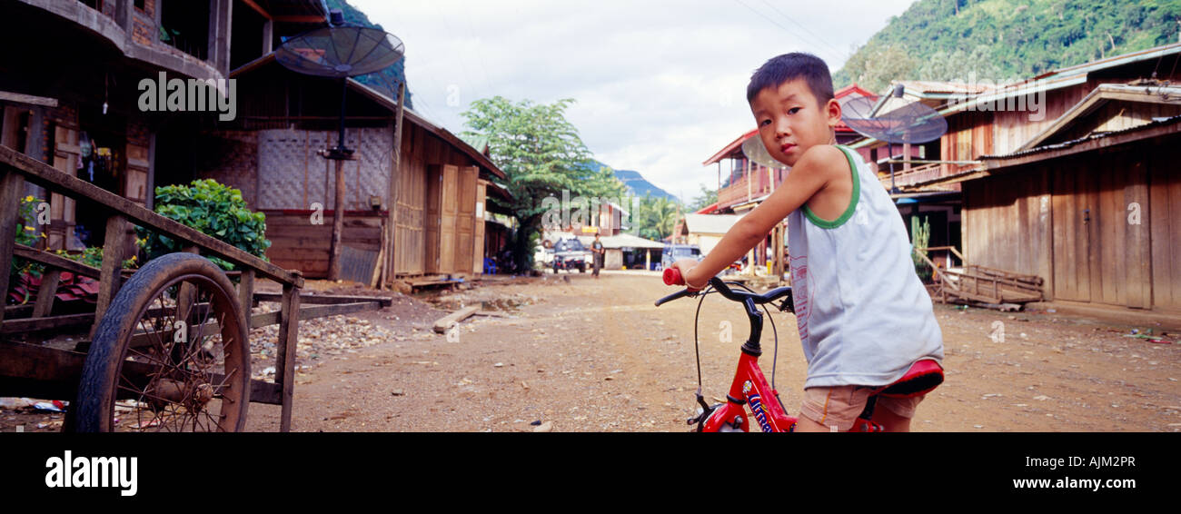 boy on bike in rural village, Laos Stock Photo - Alamy