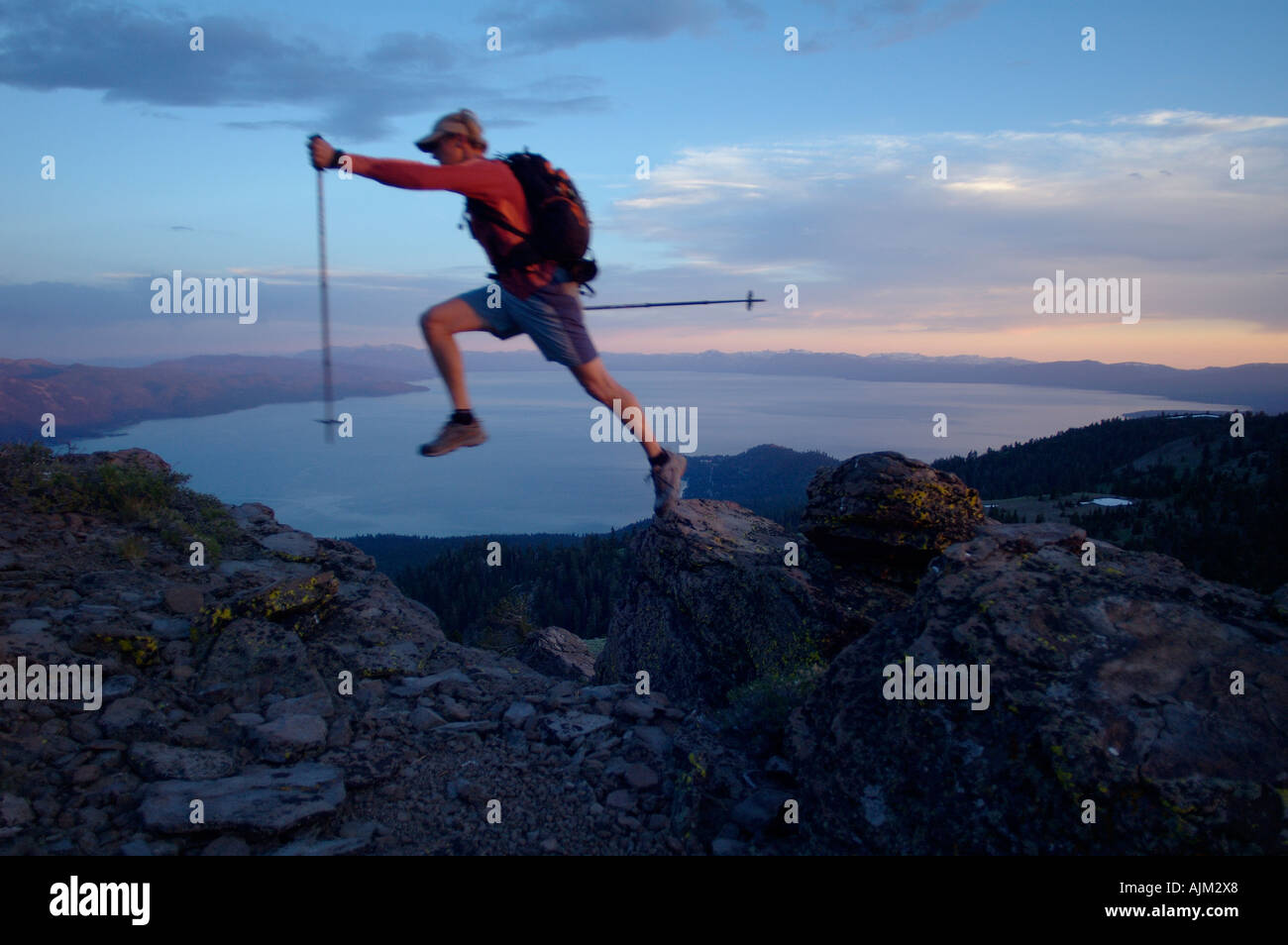 A man running above Lake Tahoe on the Tahoe Rim Trail at sunset Stock ...