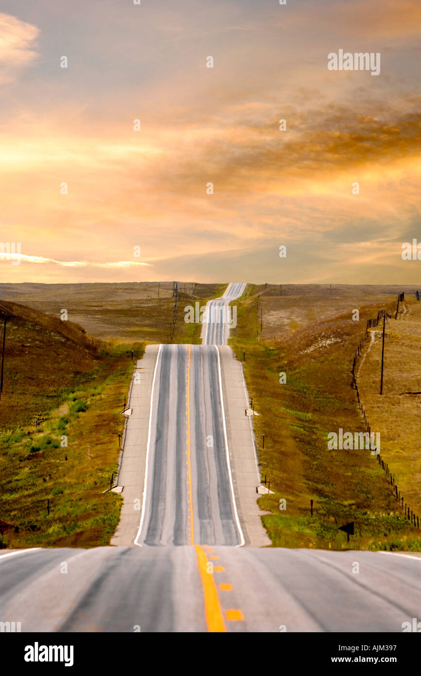 vertical image of hilly continuous road with sunset Stock Photo - Alamy