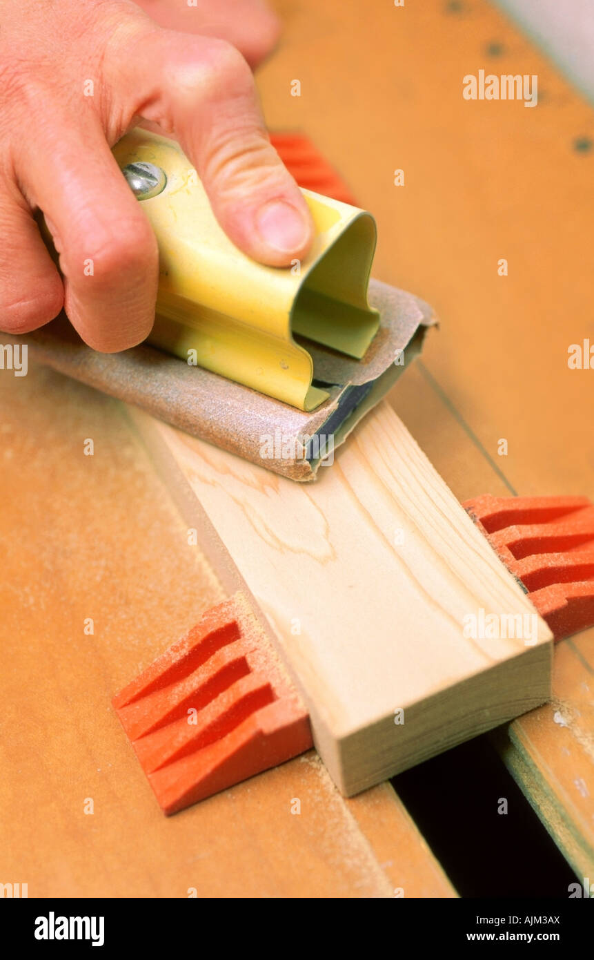 Man sanding wood Stock Photo - Alamy