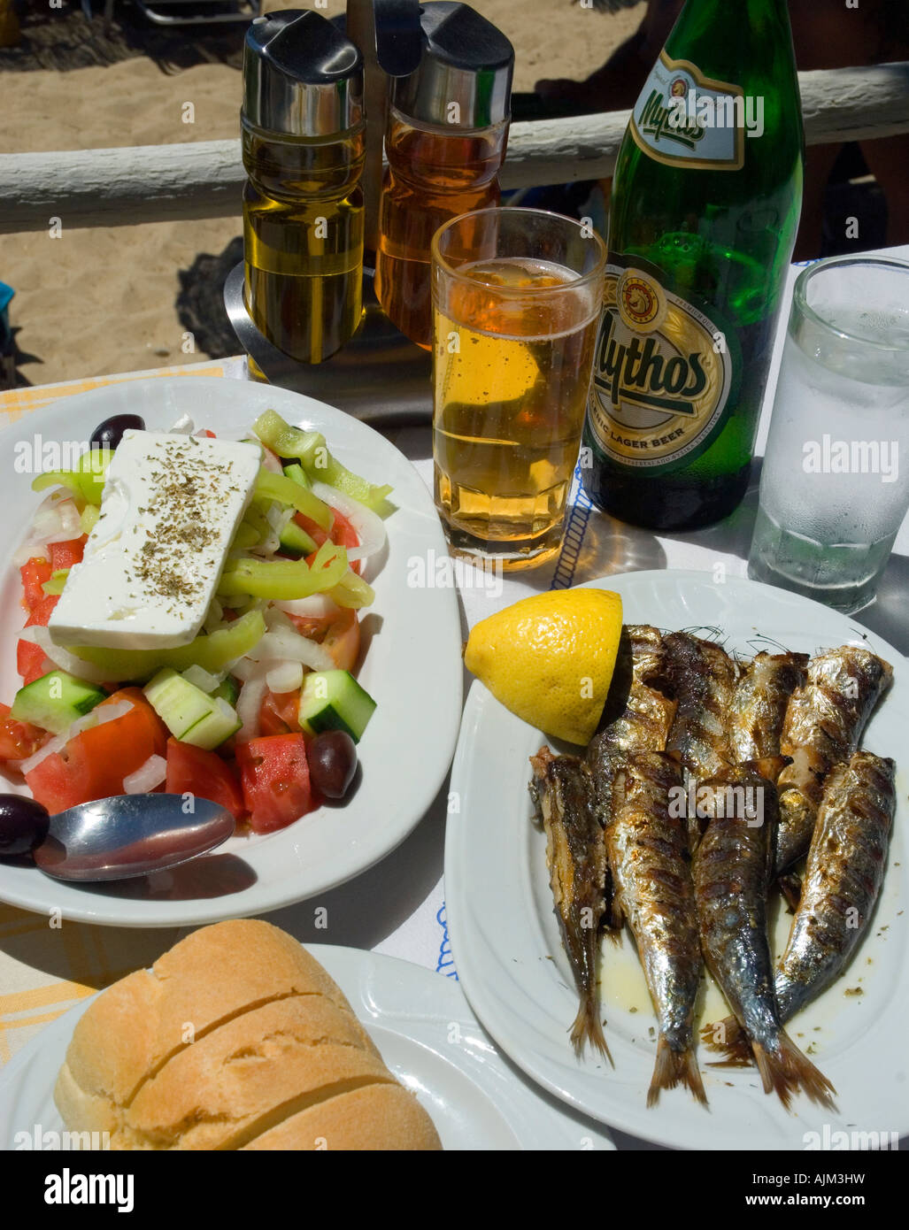 Outdoor al fresco Greek taverna meal Greek salad grilled sardines cold ...
